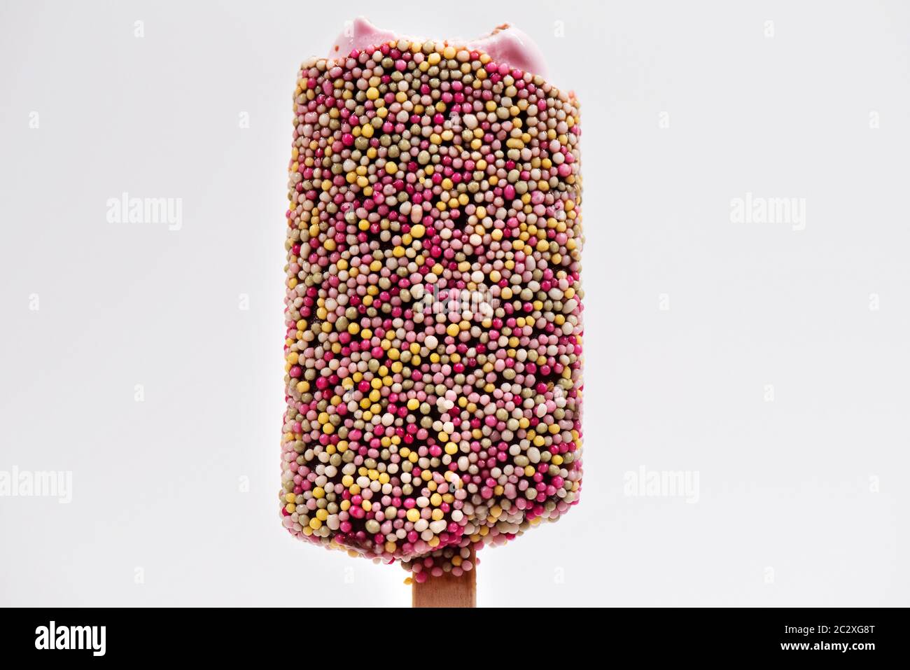 Ice cream on stick with colorful sprinkles over light background Stock ...