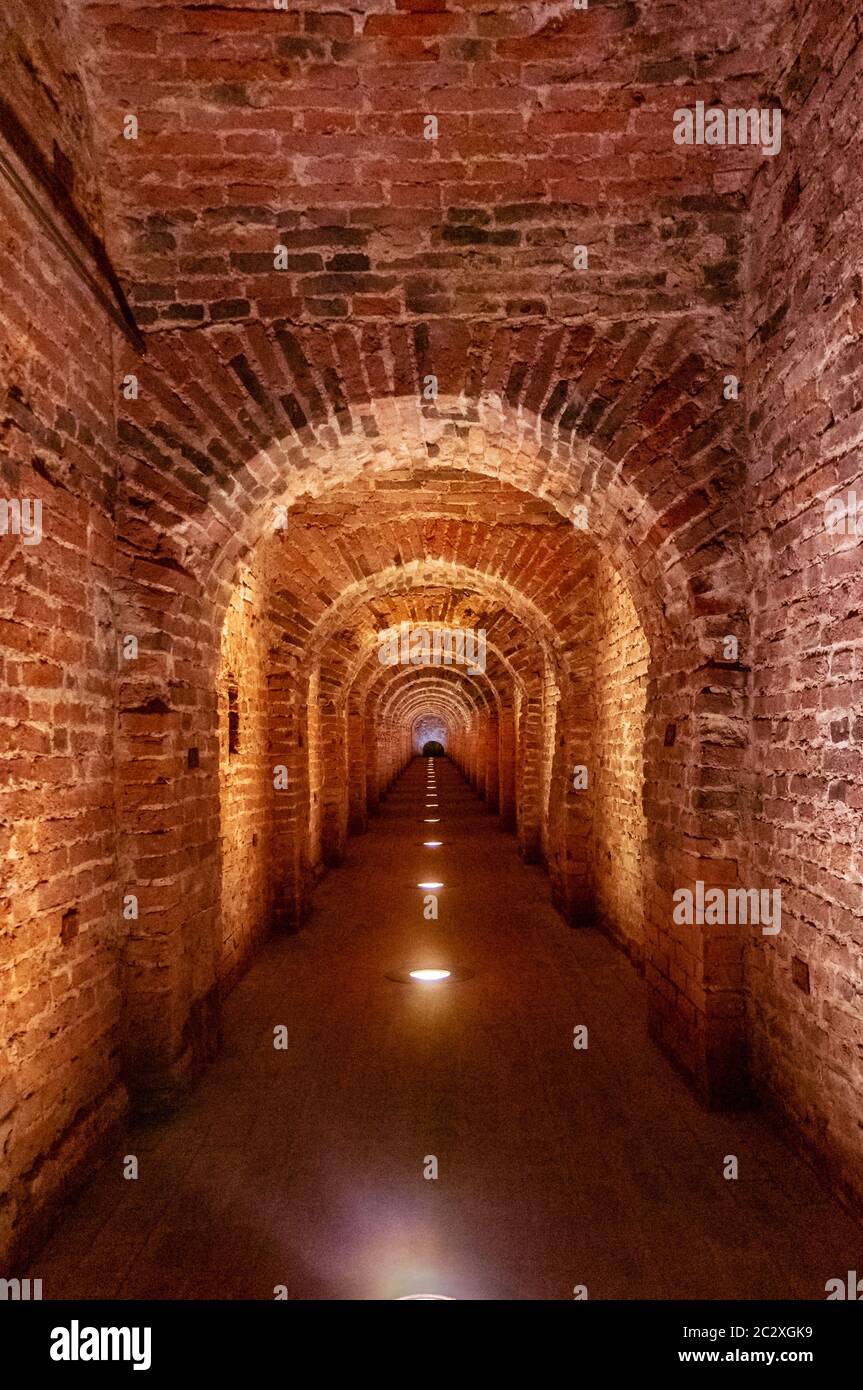 Brick archway made of red bricks as a passage between the two wings of ...