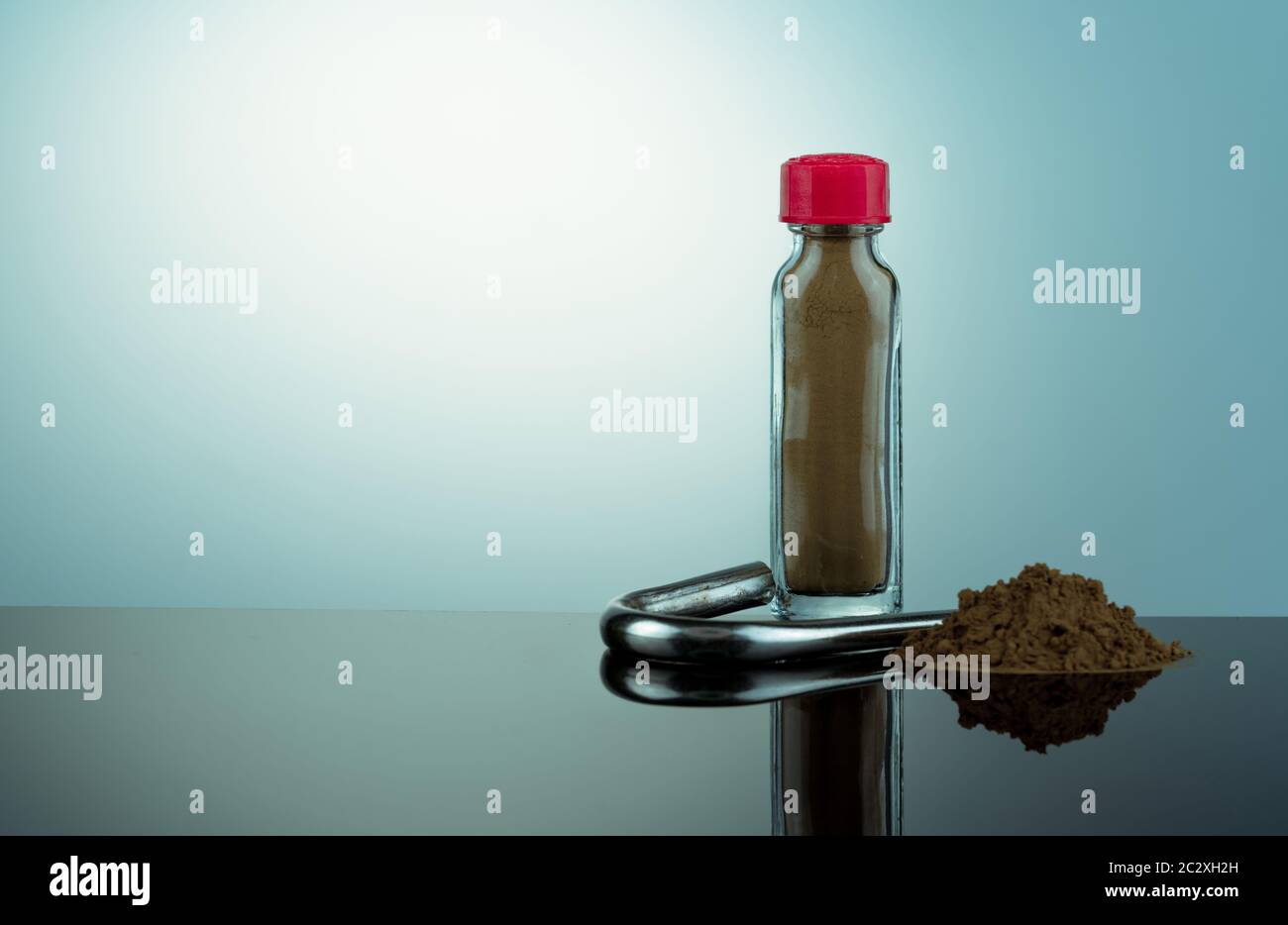 Thai herbal powders snuff in transparent glass bottle with red cap and ...