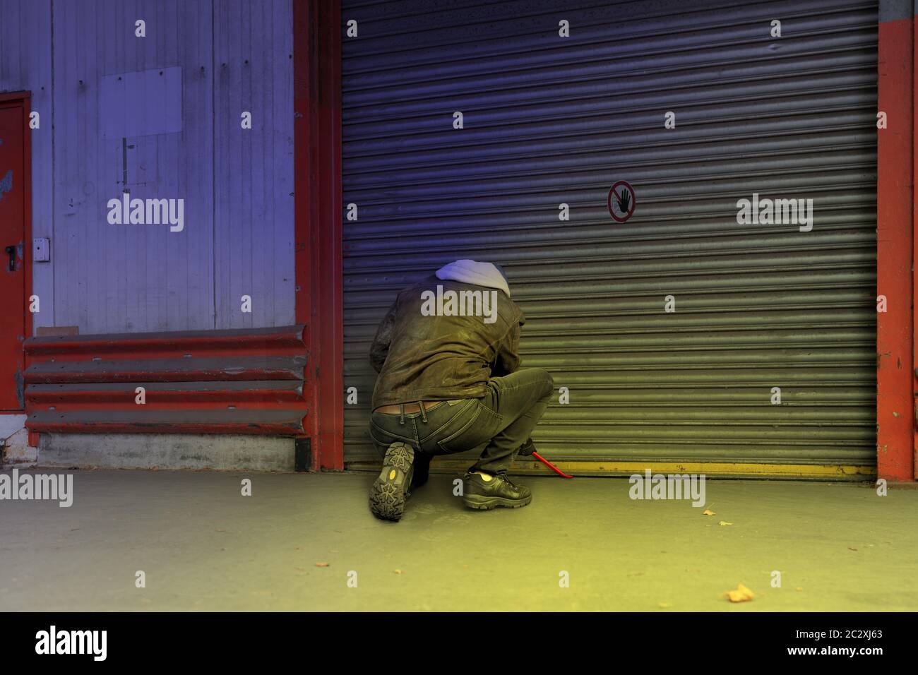 thief tries to break a gate at a company with a crowbar Stock Photo - Alamy