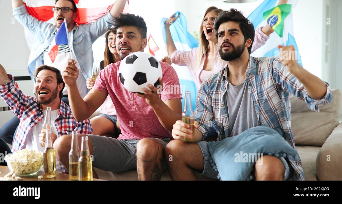 Excited fans of soccer friends celebrating winning match Stock Photo ...
