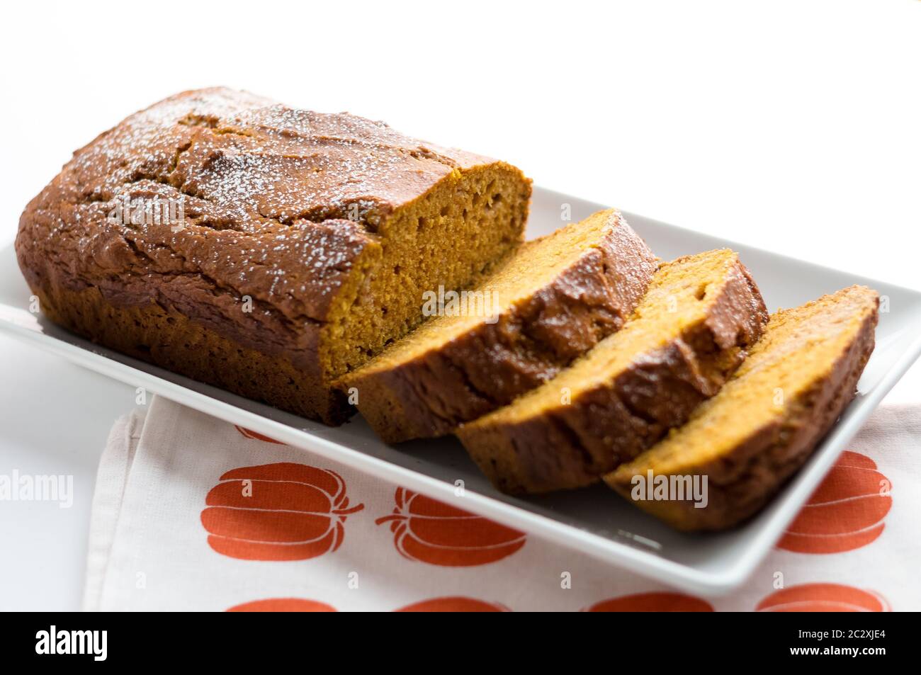 Slices of pumpkin bread. Pumpkin bread is a thick sweet cake loaf made ...