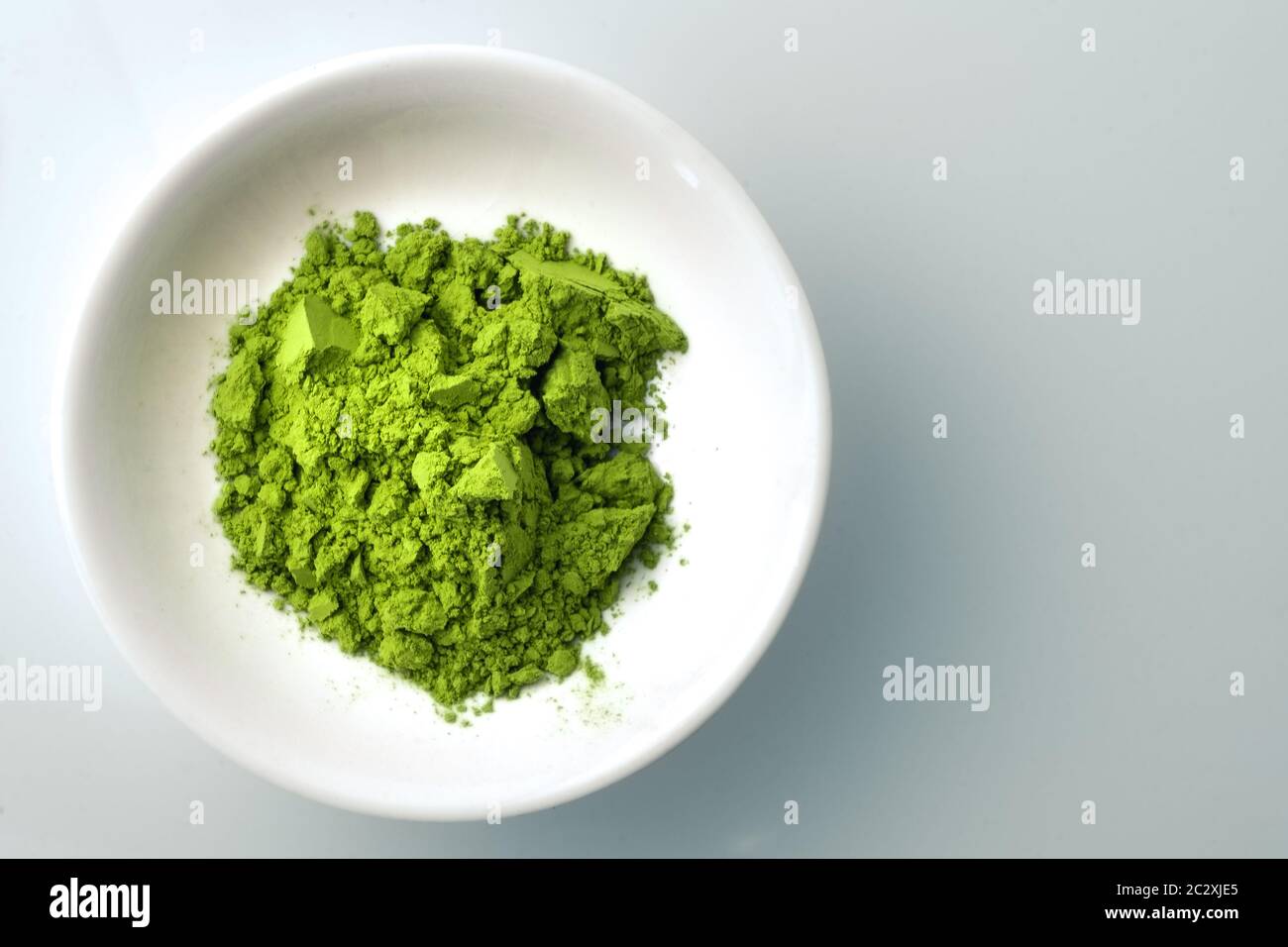 Matcha powder in white bowl. Matcha is finely ground japanese green tea ...