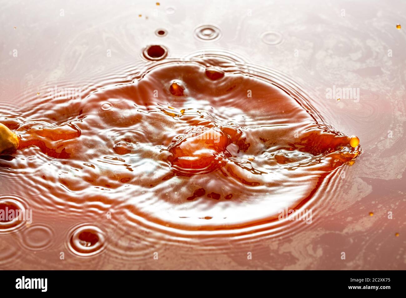 Rusty water drops splashing in dirty oily water, drops of stagnant ...
