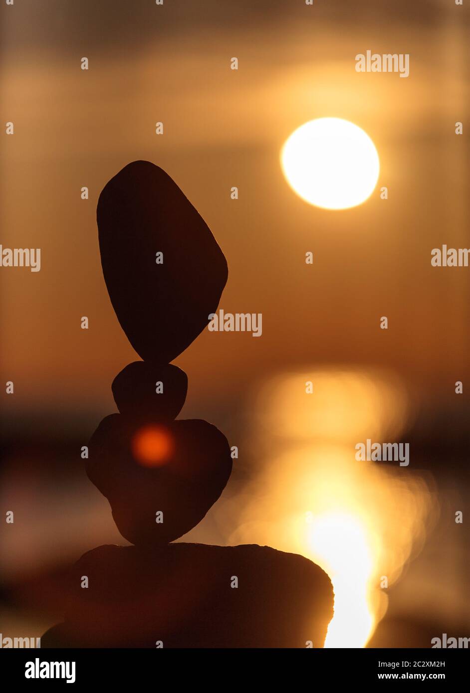 balanced stones on the beach at sunset Stock Photo - Alamy