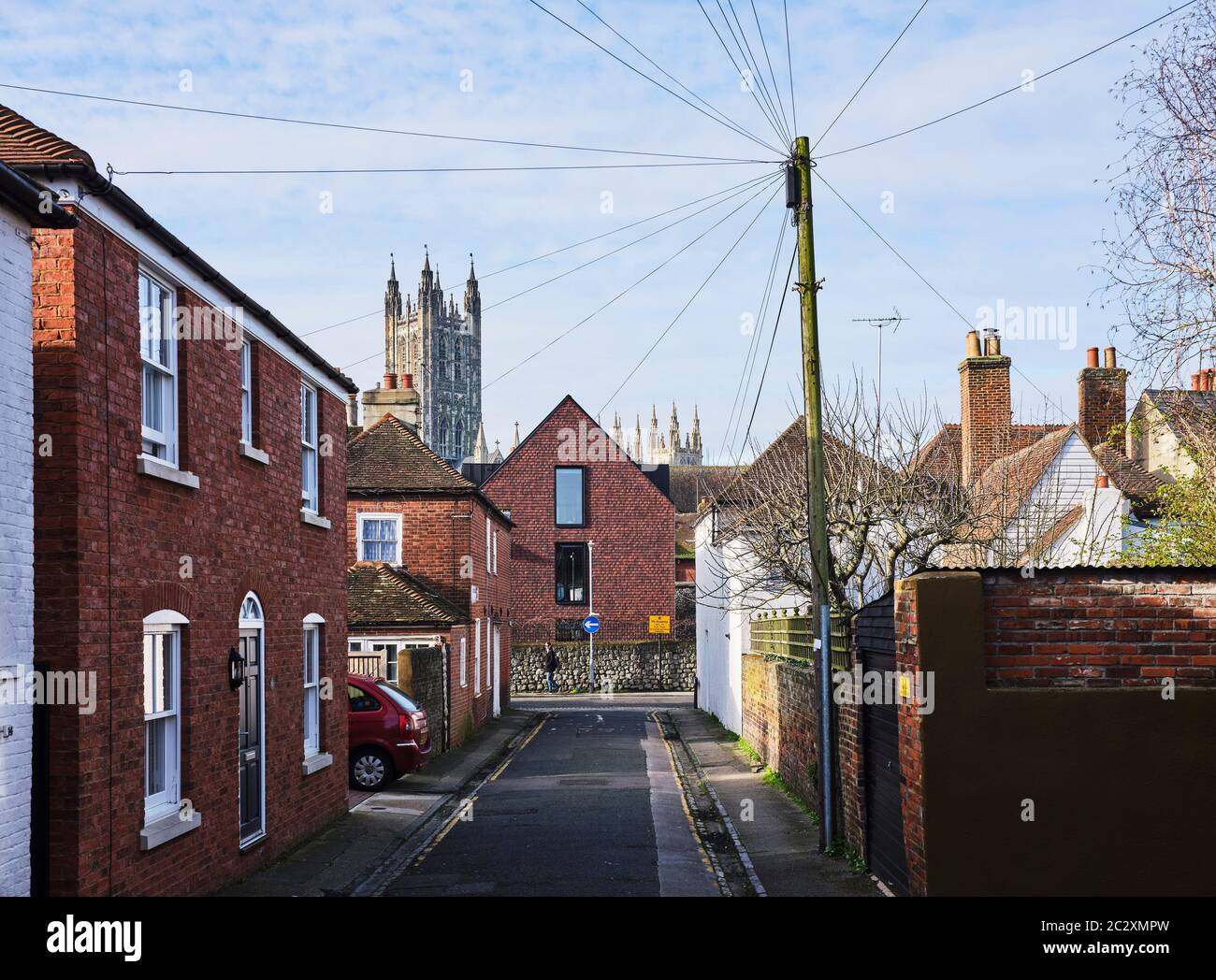 View down street with telephone pole, pitched roofs, the building and ...