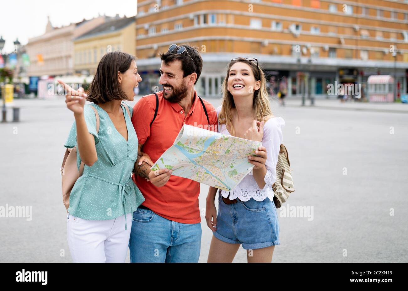 Happy friends enjoying sightseeing tour in the city Stock Photo - Alamy