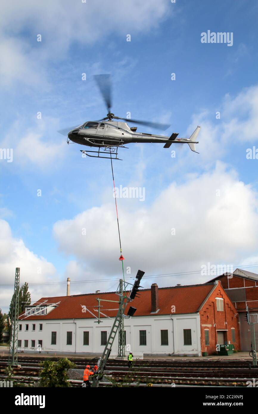 A cargo helicopter on the railway construction site KÃ¶then, mast ...