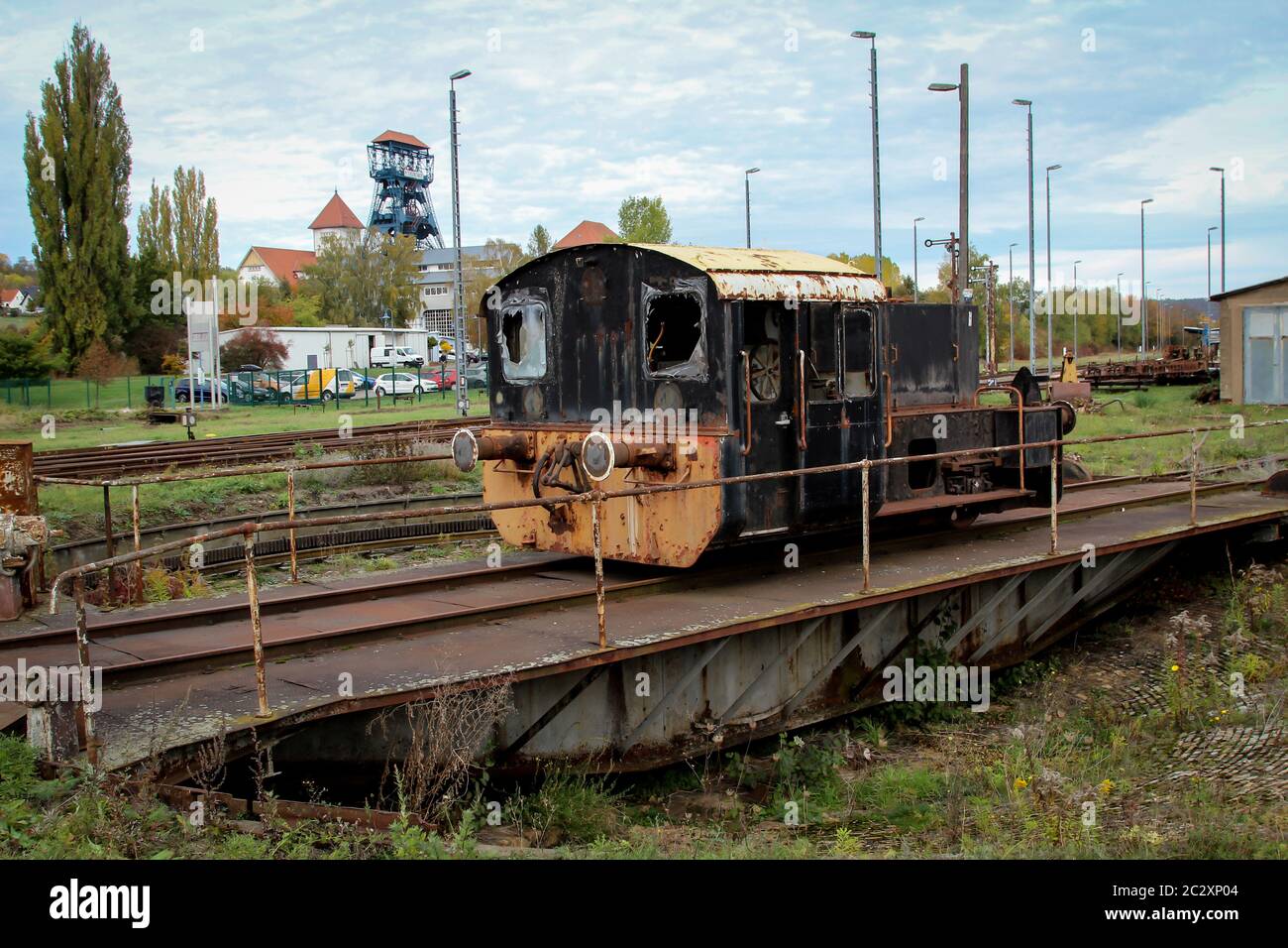 A burned shunting locomotive stands off the normal railroad tracks ...
