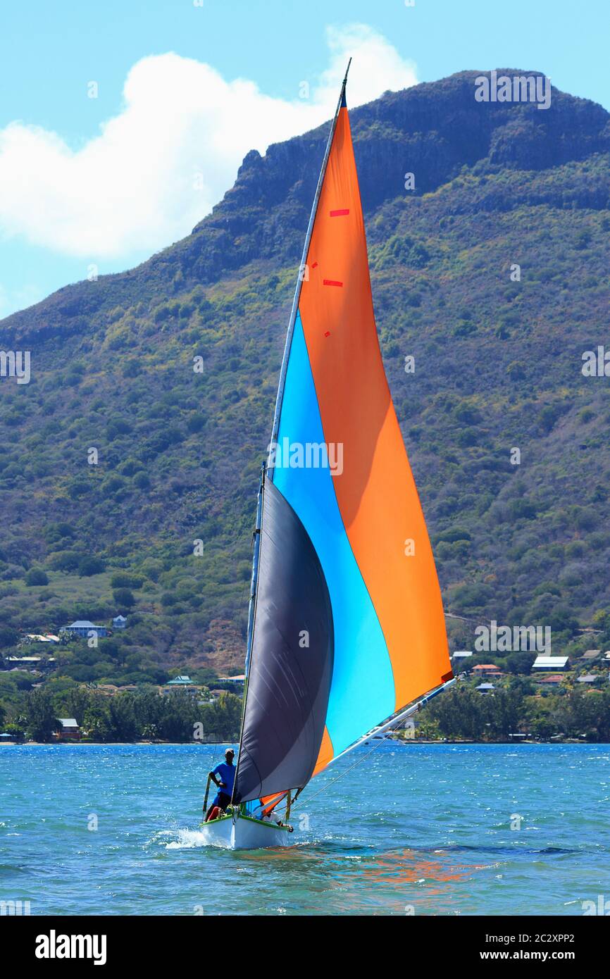 Image showing a boat locally known as "pirogue", with a colorful sail ...
