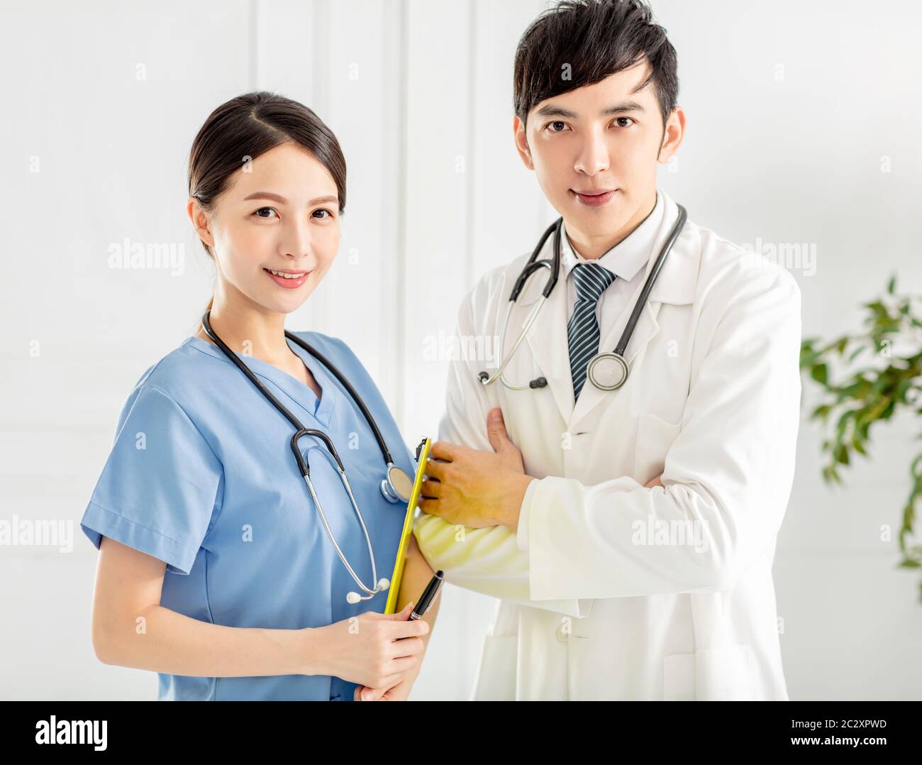 Two smart and professional smiling doctors Stock Photo - Alamy