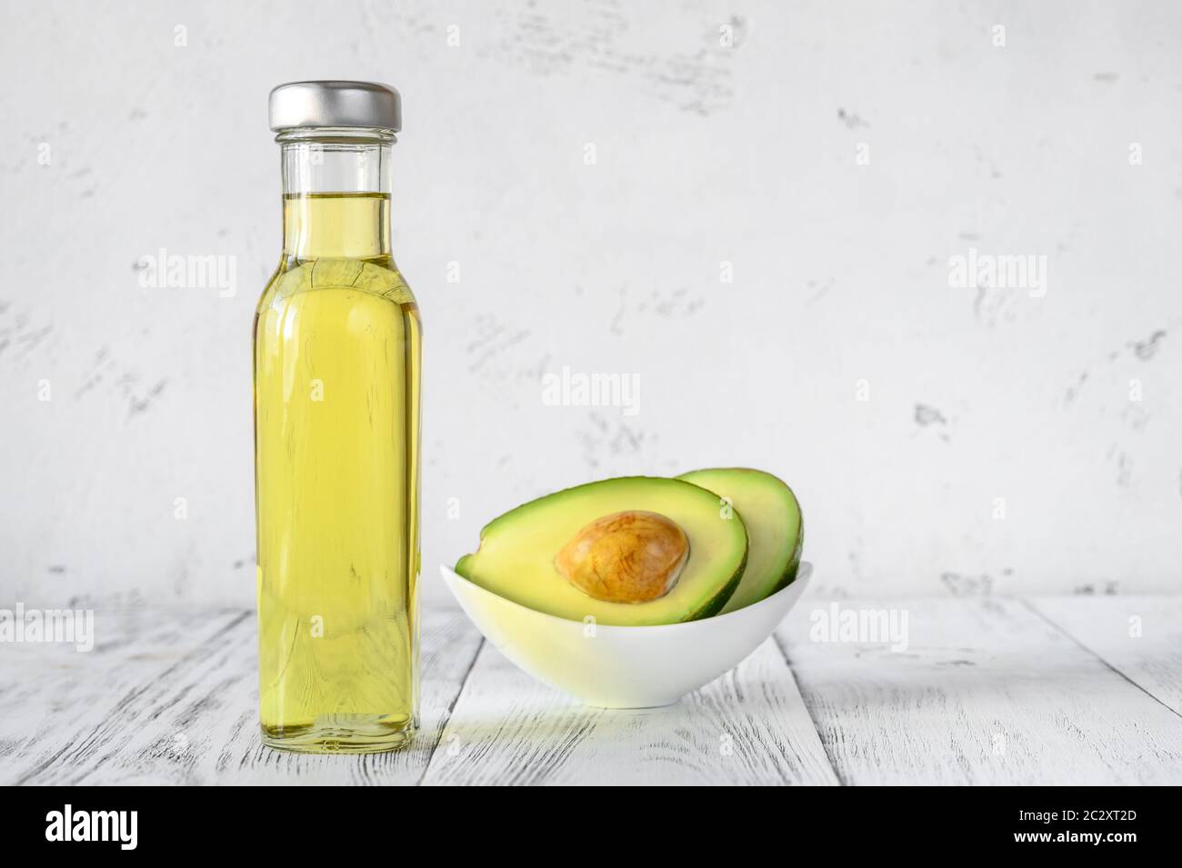 Bottle of avocado oil with fresh avocado: top view Stock Photo - Alamy