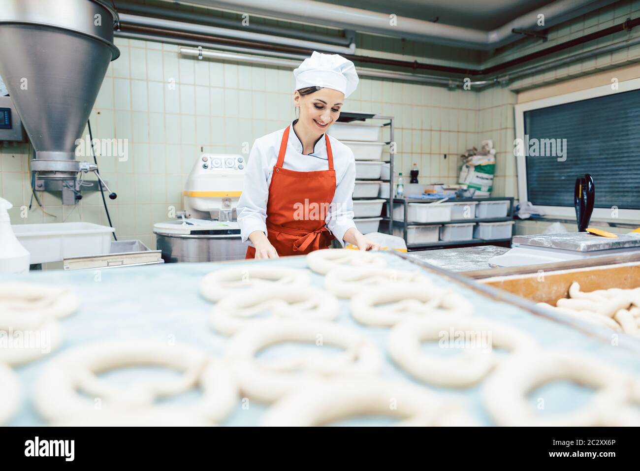 Baker showing sheet with bread ready to be baked into the camera Stock ...