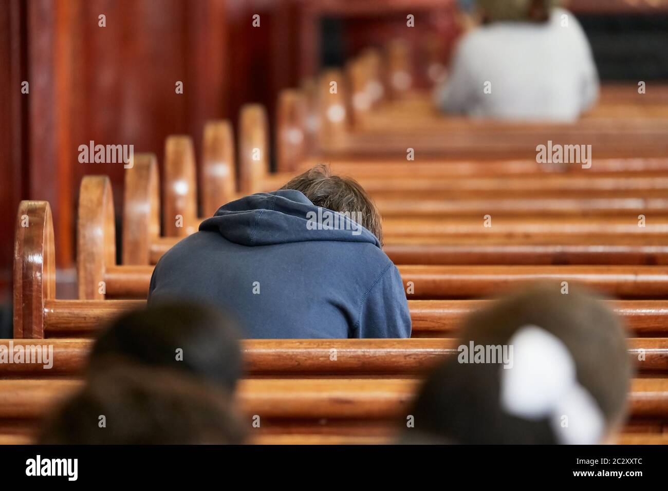 People praying in church benches Stock Photo - Alamy