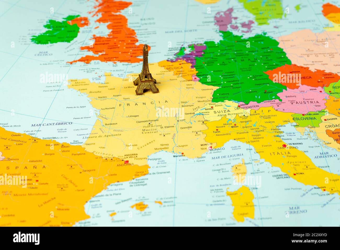 Miniature statue of the effiel tower placed in France on a colorful map ...