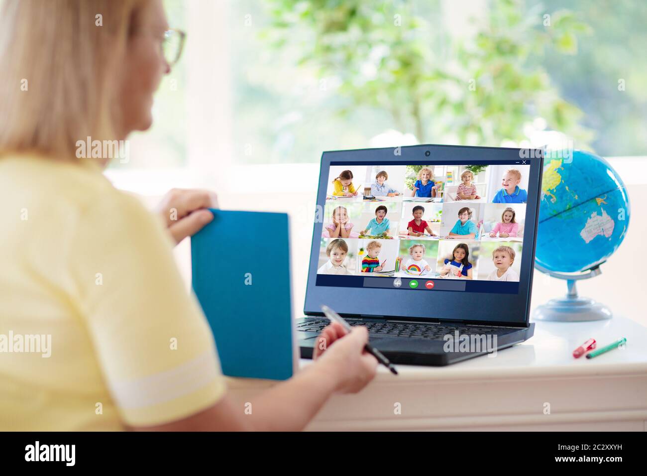 Online remote learning. Teacher with computer having video conference ...