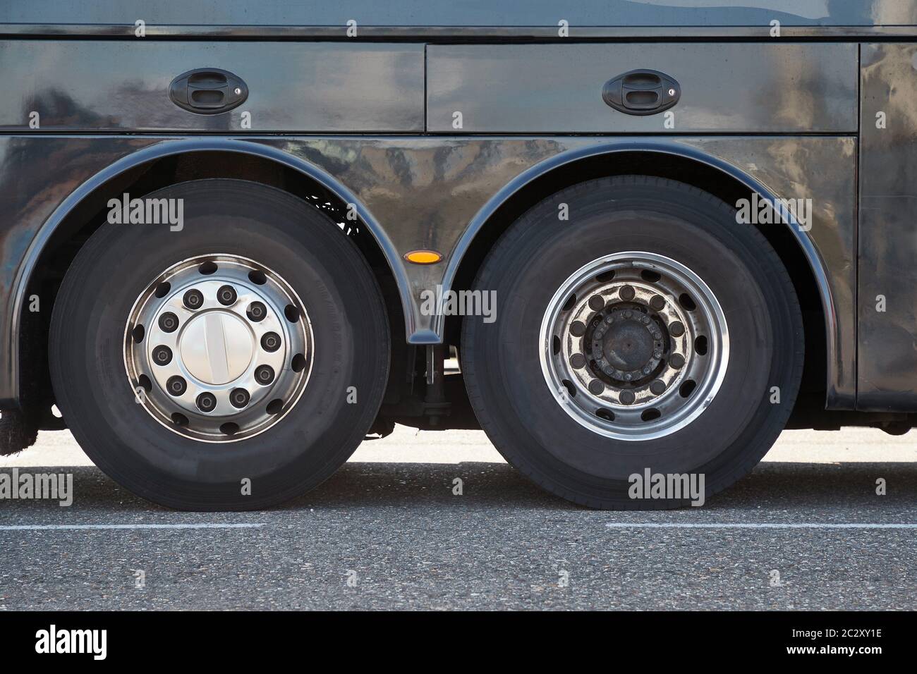 Bus wheels on the back axles of a long distance tour bus Stock Photo ...
