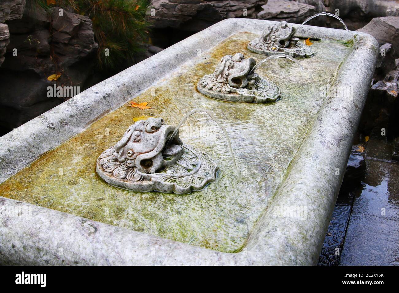 Image of water exiting from carved marble lion heads, Baotu Springs, Jinan City, Shandong ...