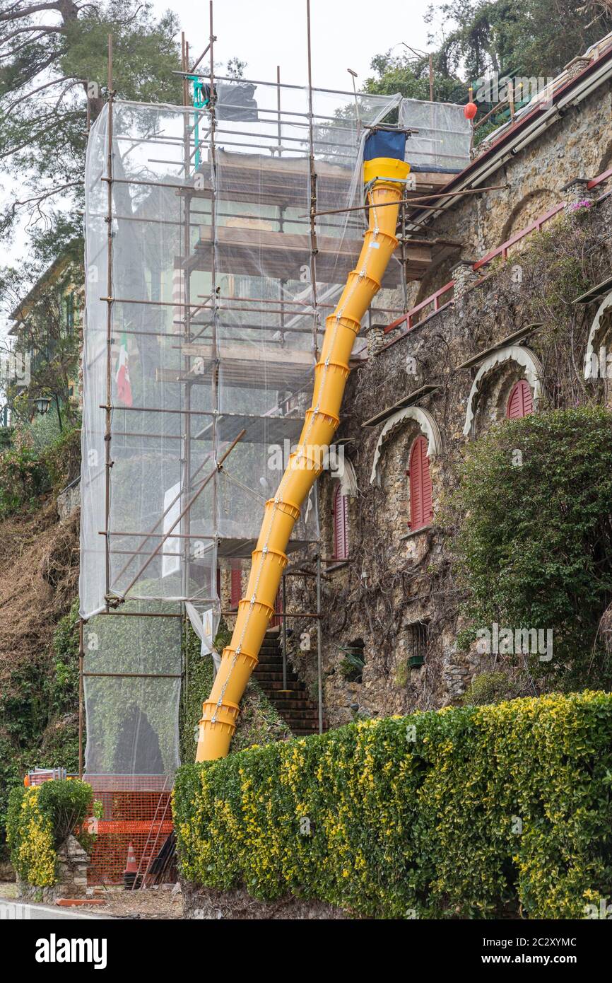 Debris Chute and Scaffolding at Construction Site Stock Photo - Alamy