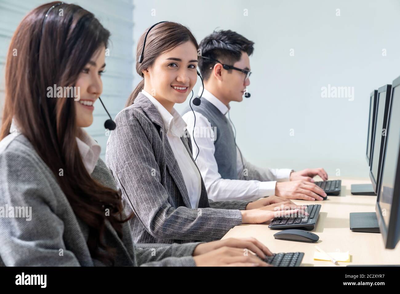 Smiling call Center working Stock Photo - Alamy