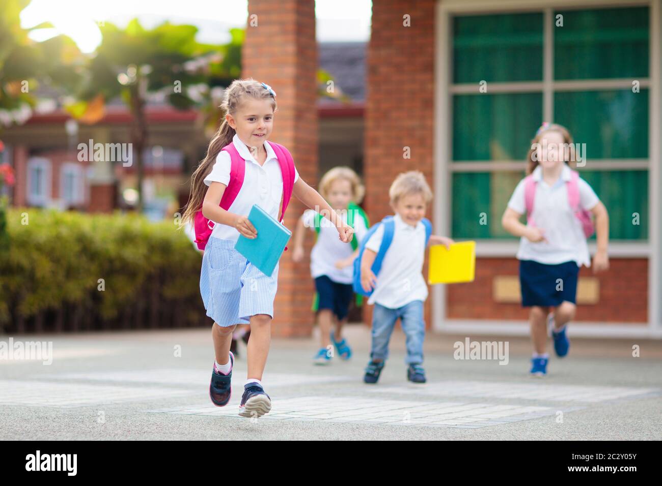 Child going to school. Boy and girl holding books and pencils on the ...