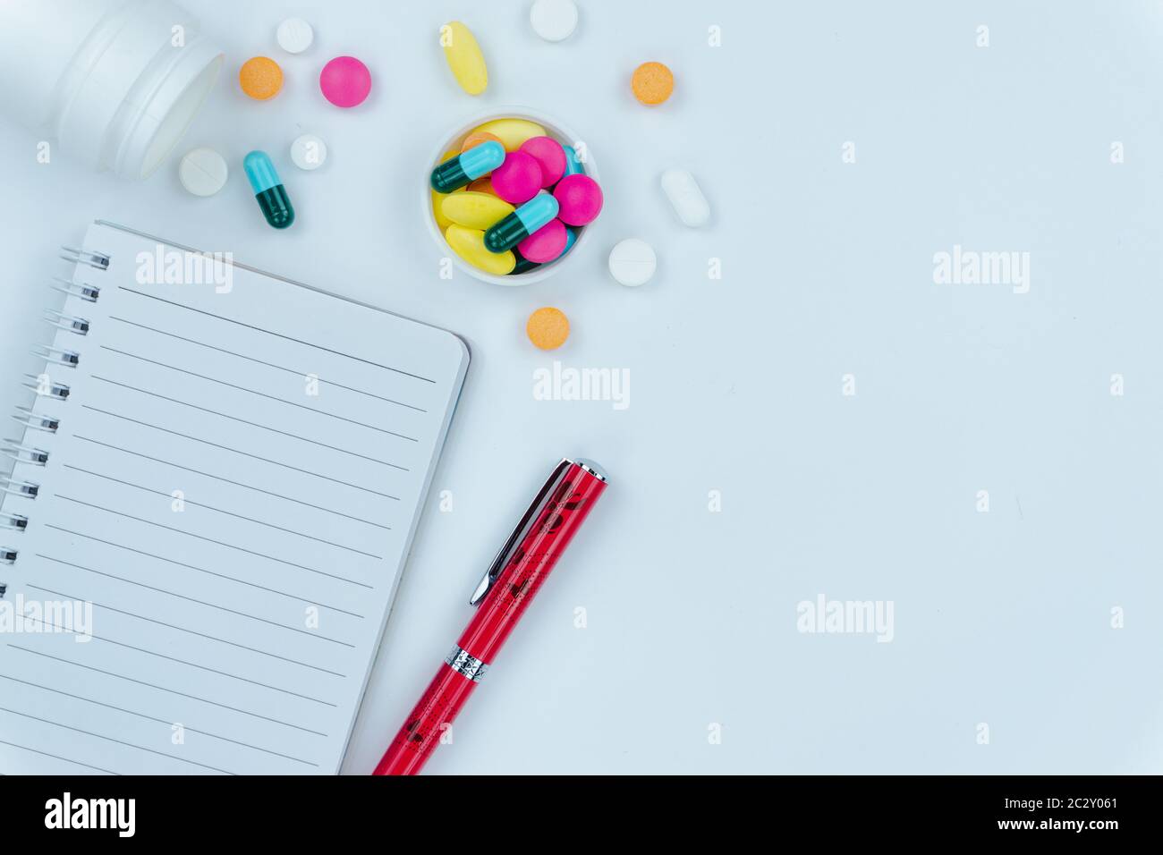 Assorted pharmaceutical medicine pills, tablets and capsules, pen and ...