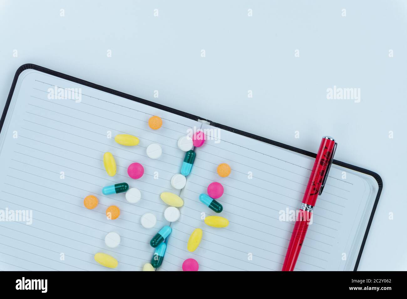 Assorted pharmaceutical medicine pills, tablets and capsules, pen and ...