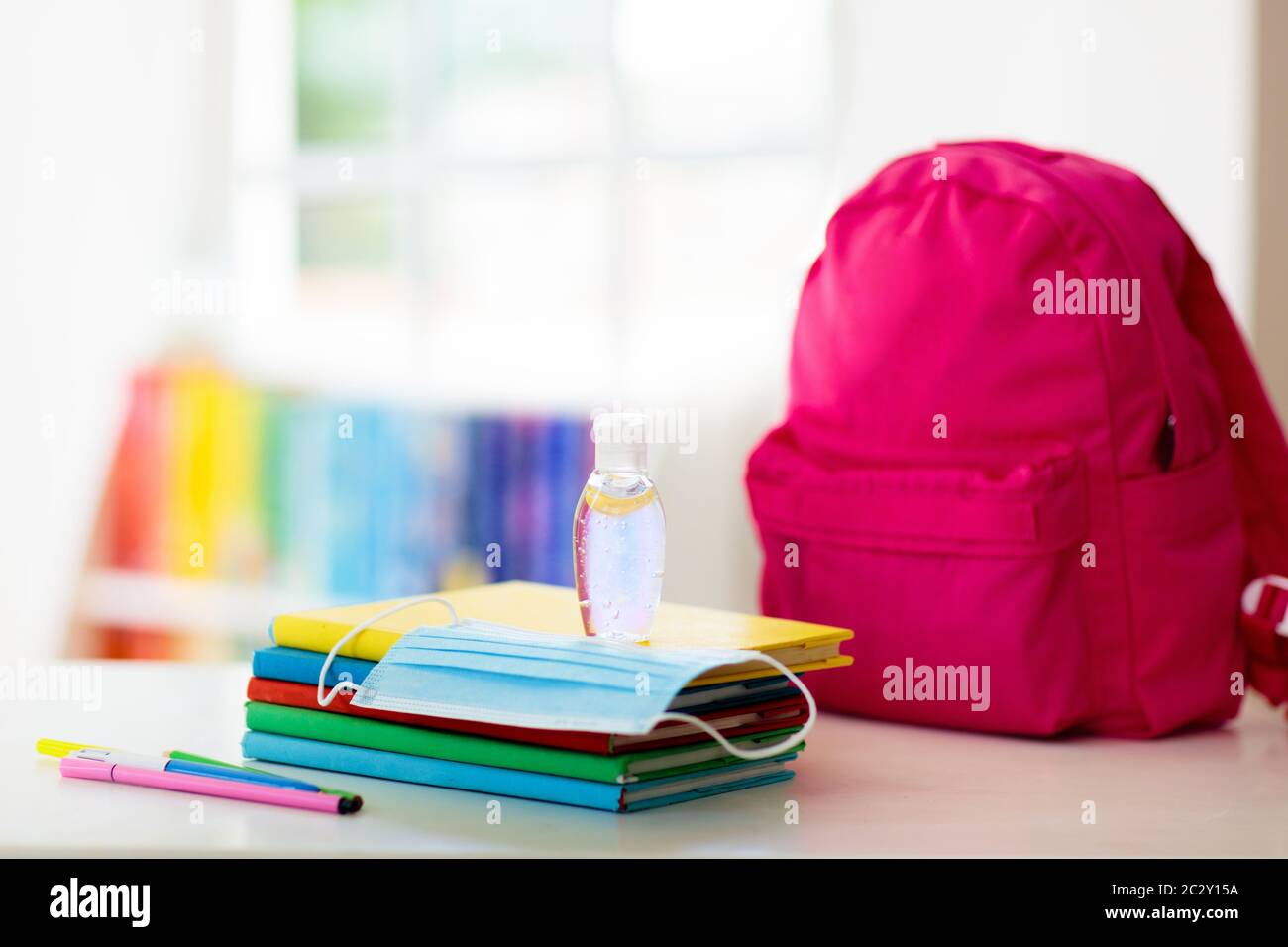 Backpack of school child with face mask and sanitizer. Student safety ...