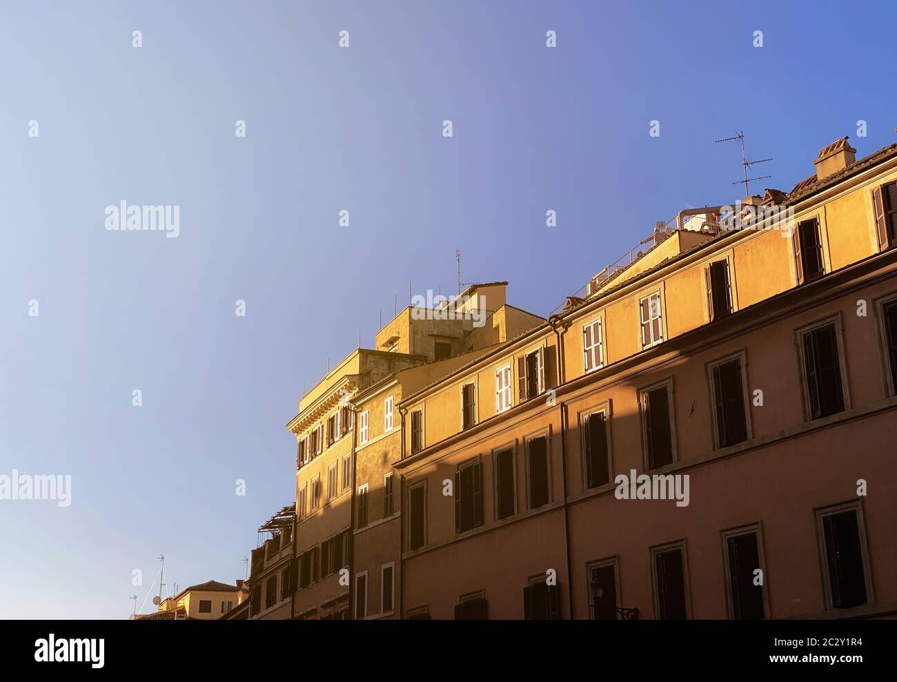 the facades of ancient buildings illuminated by the light of the sun at ...