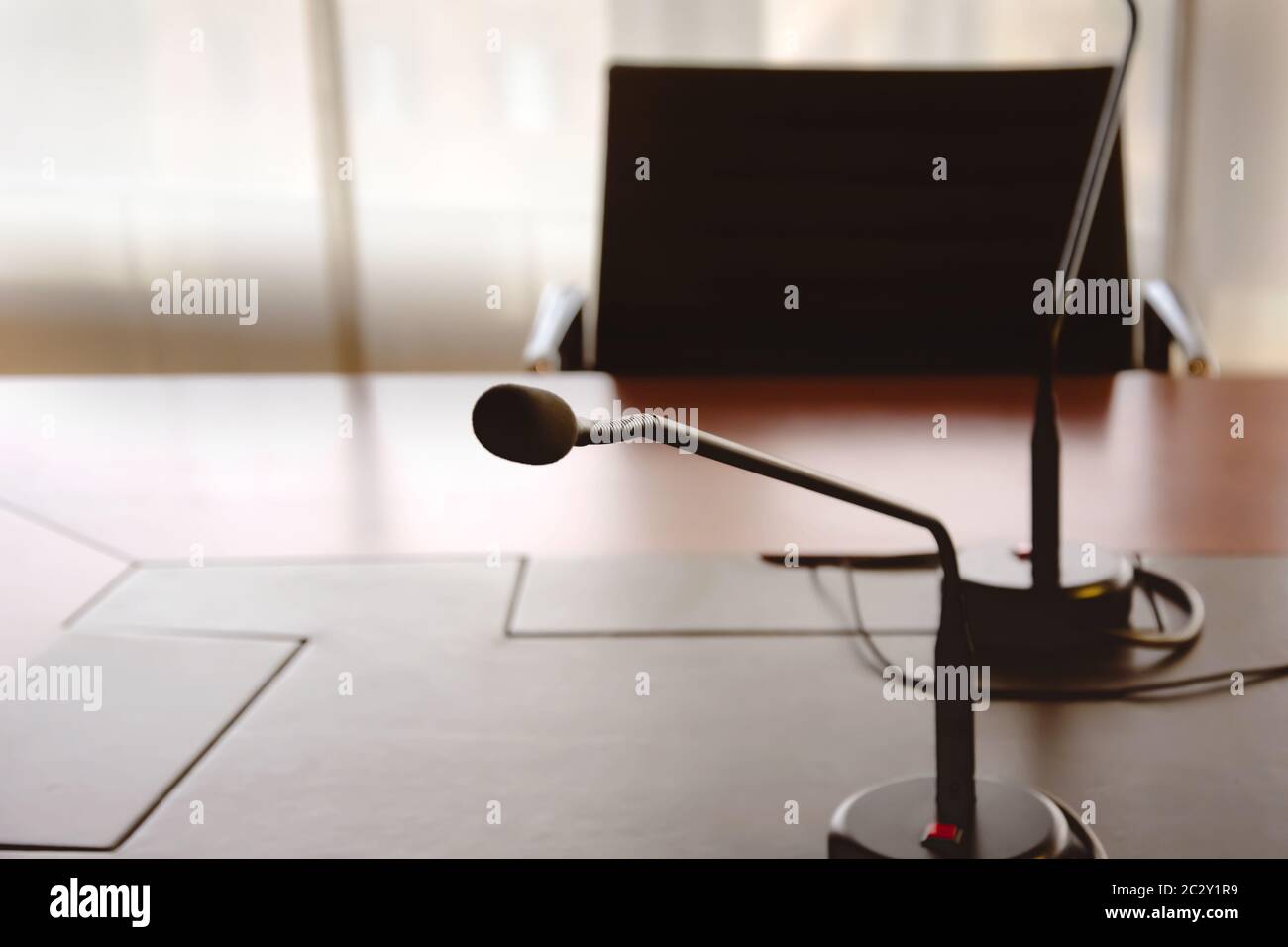 microphone on a wooden table and an empty chair in a boardroom Stock ...