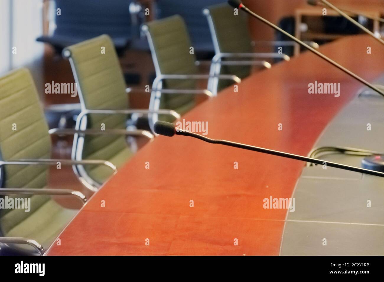 microphone on a wooden table and empty chairs in a boardroom Stock ...