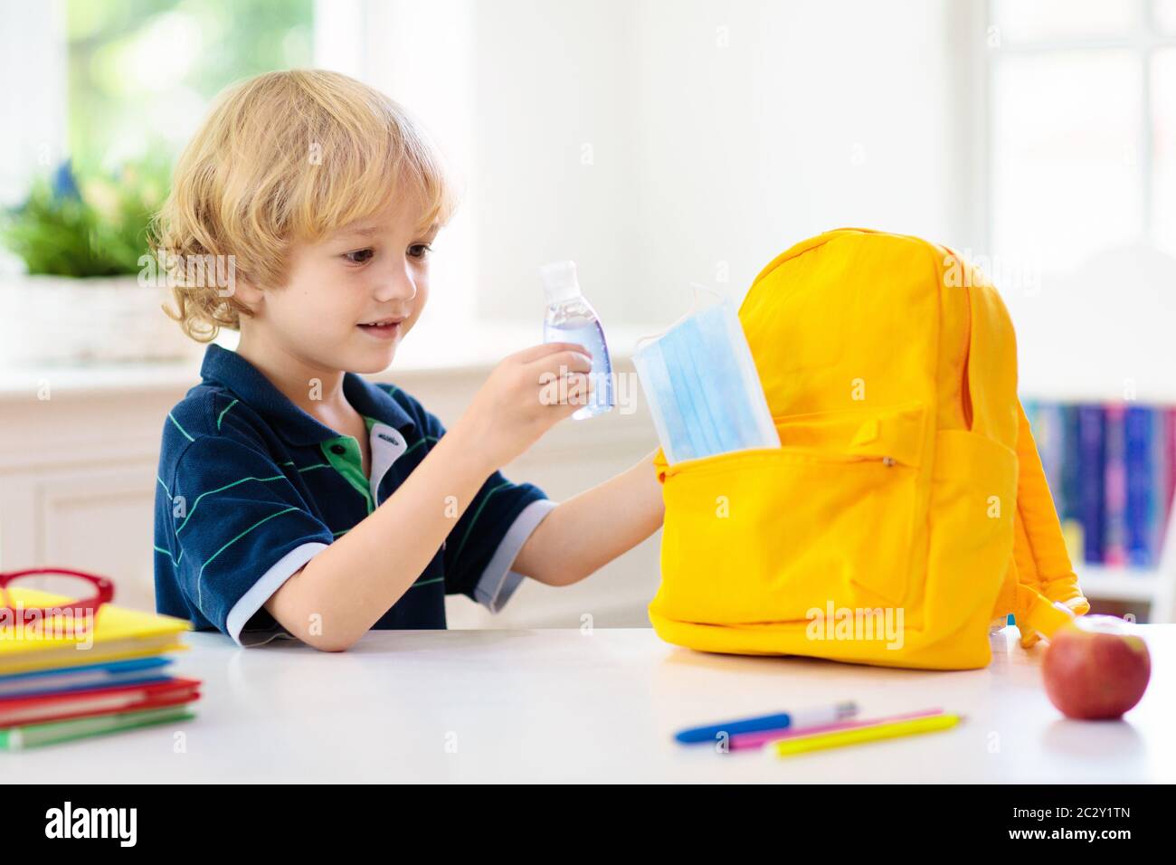 School child with backpack, face mask and sanitizer. Student safety ...