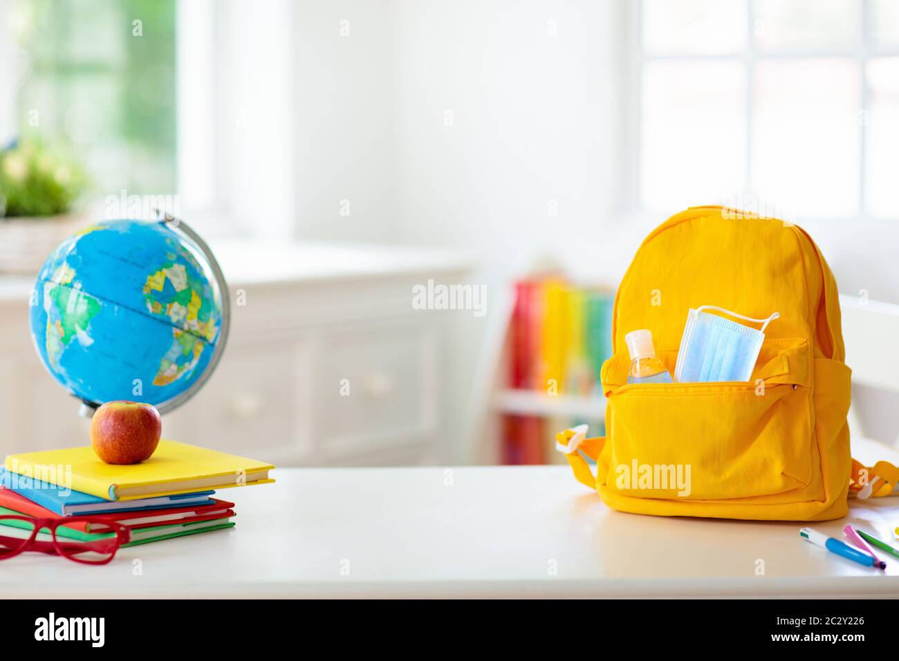 Backpack of school child with face mask and sanitizer. Student safety ...