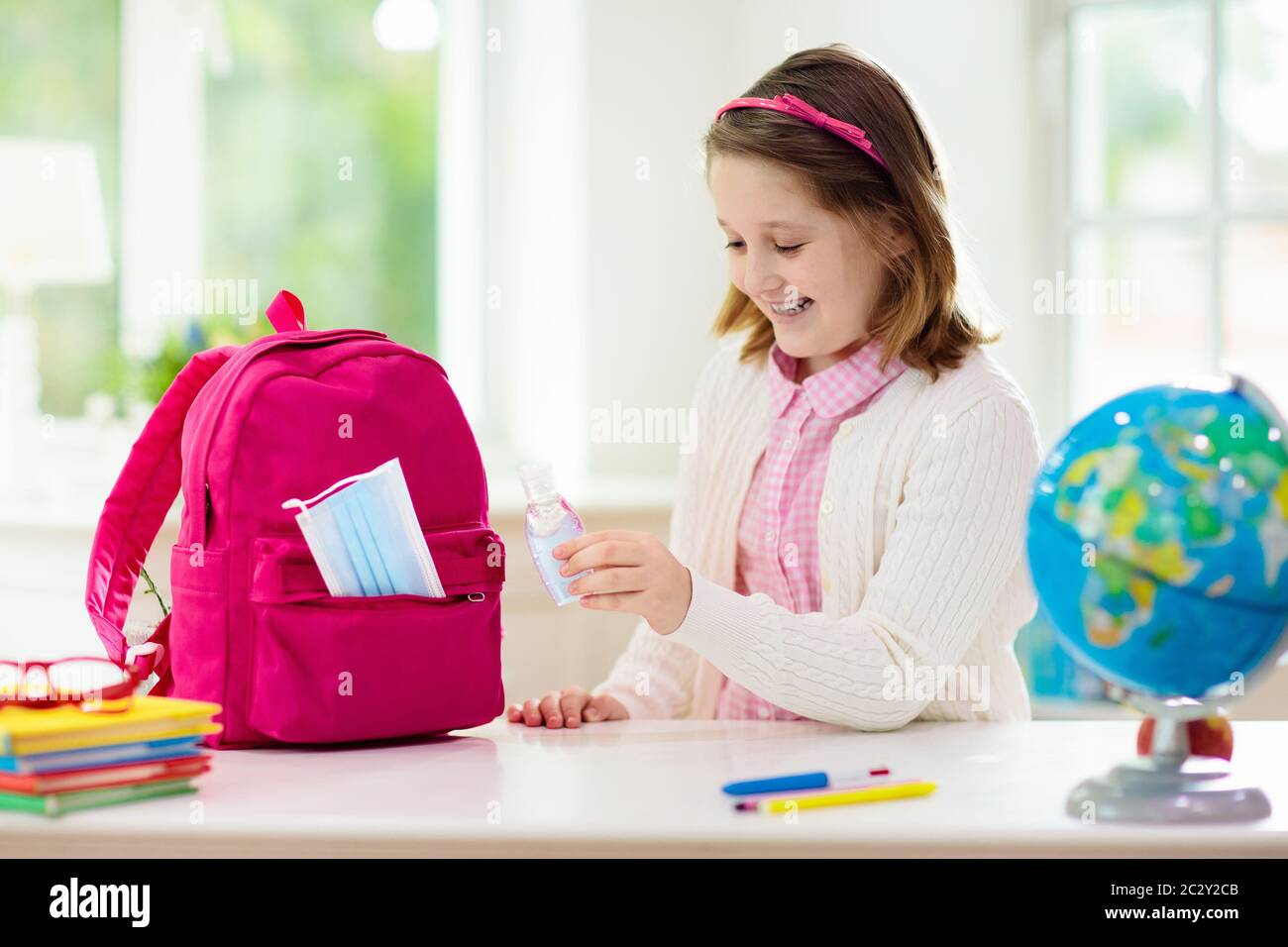 School child with backpack, face mask and sanitizer. Student safety ...
