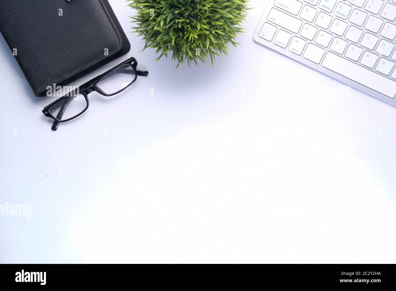 office desk with keyboard and notepad on white desk top down Stock ...