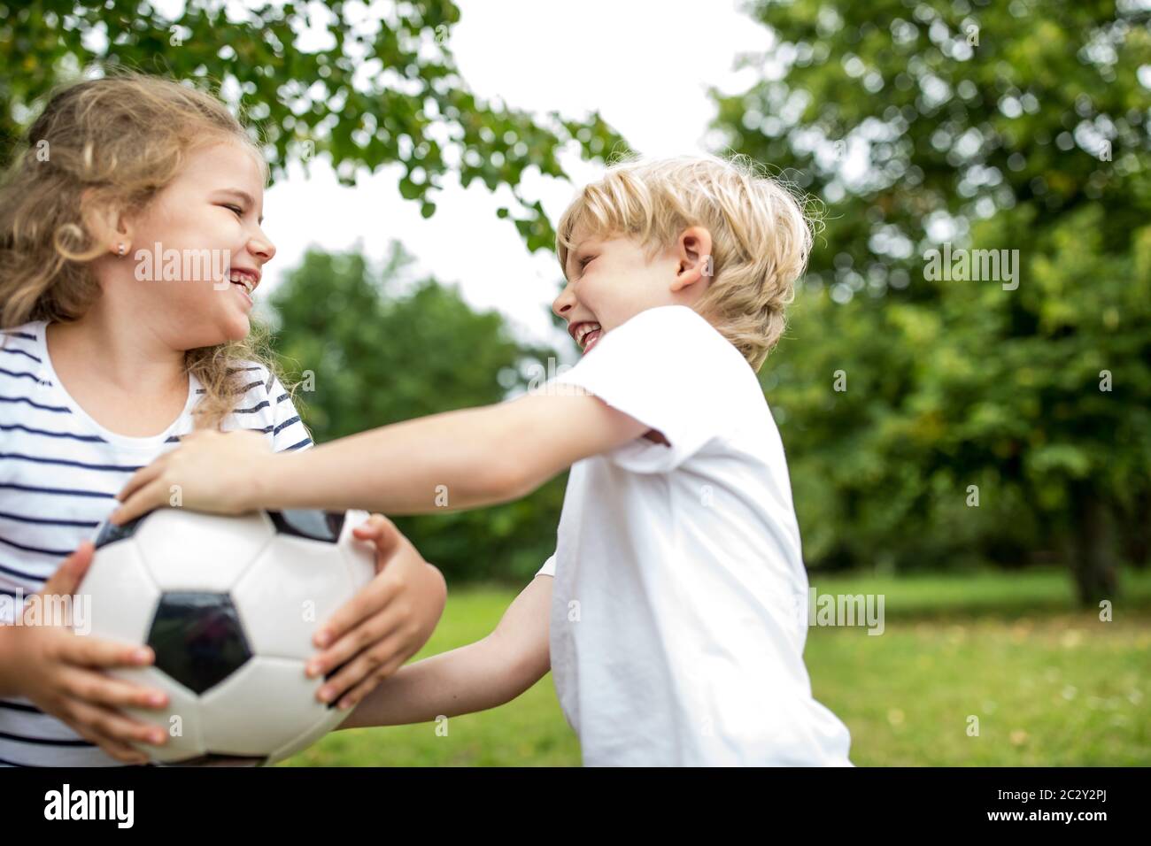 Boy fighting over ball hi-res stock photography and images - Alamy