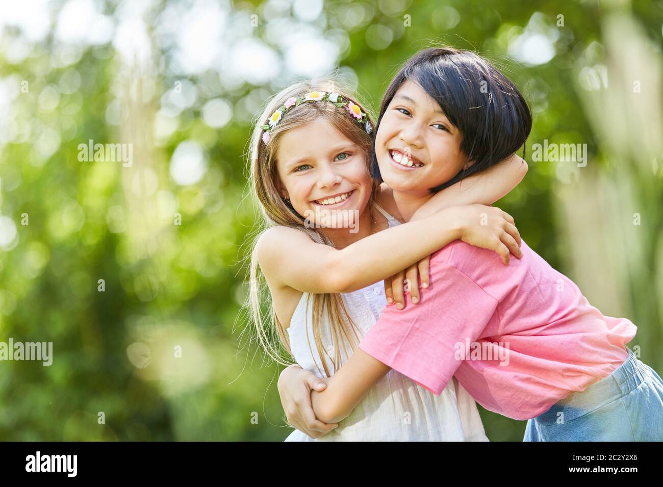 Two girls as best friends hug in nature Stock Photo - Alamy