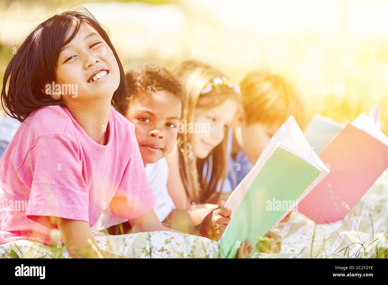 Group of elementary school children do homework together in nature in ...