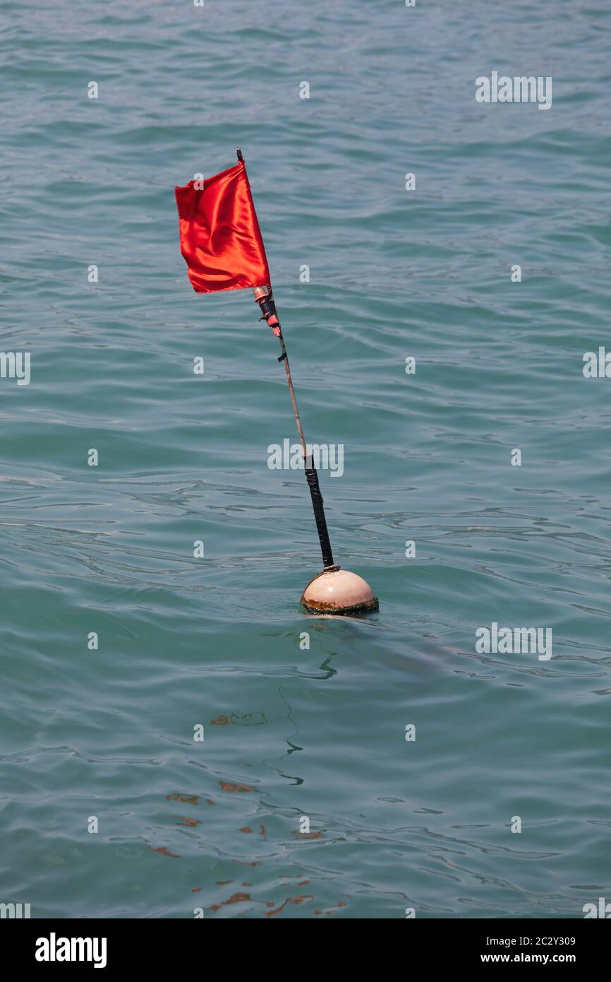 Floating Red Flag Mark in Harbour Water Warning Stock Photo - Alamy