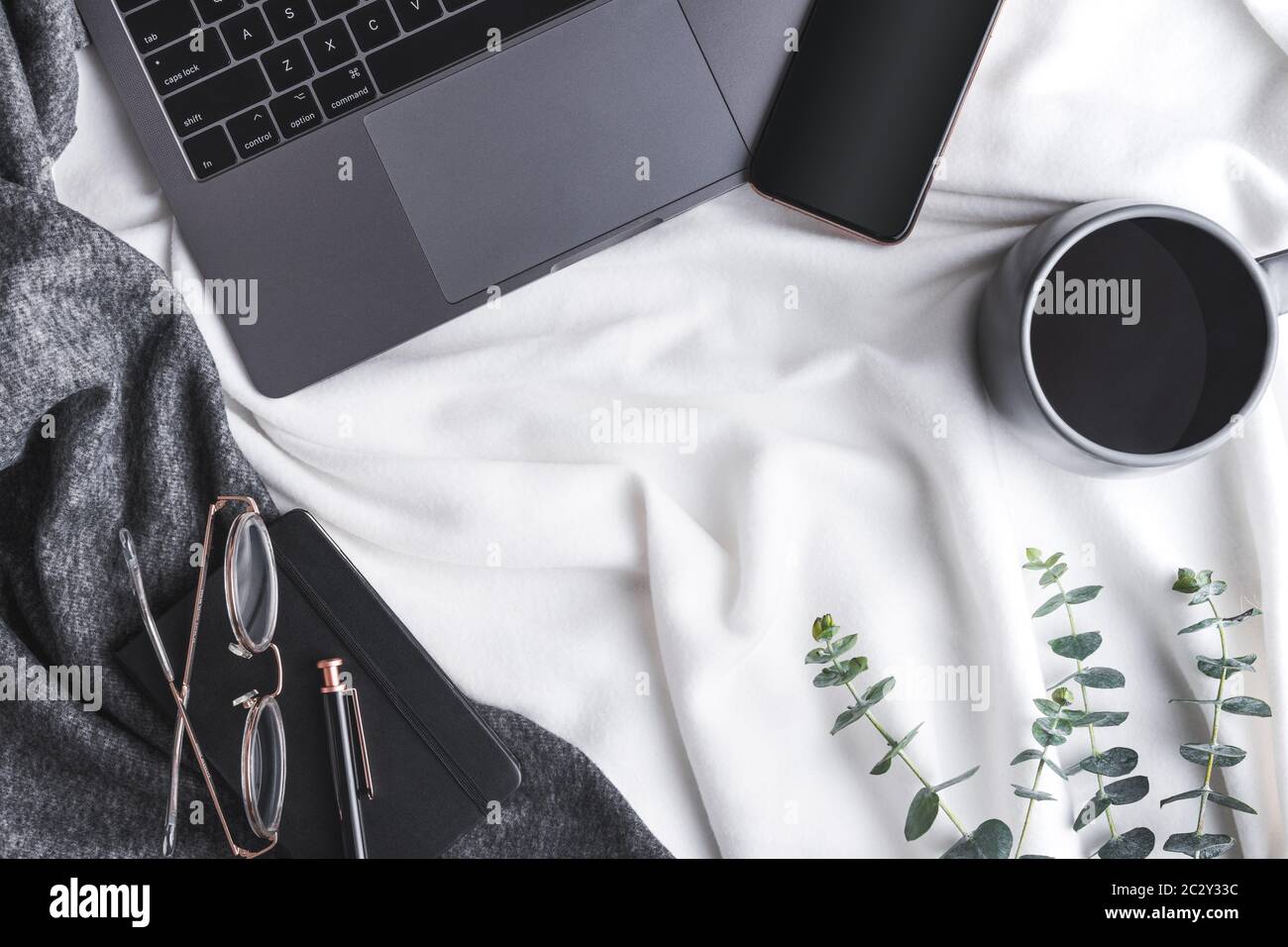 Electronics layout in a white and gray bed flat lay Stock Photo - Alamy