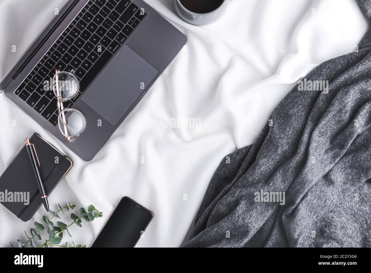 Electronics layout in a white and gray bed flat lay Stock Photo - Alamy