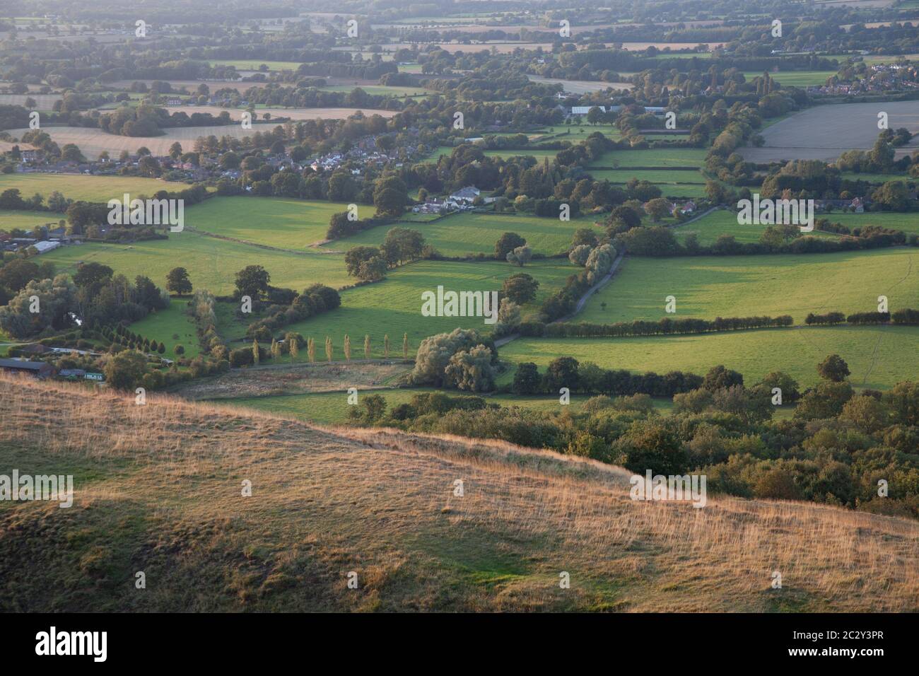 Aerial view of bucolic farmland and British countryside summer sunset ...