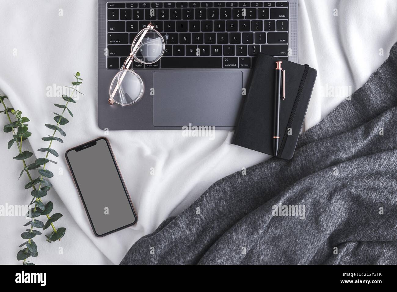 Electronics layout in a white and gray bed flat lay Stock Photo - Alamy