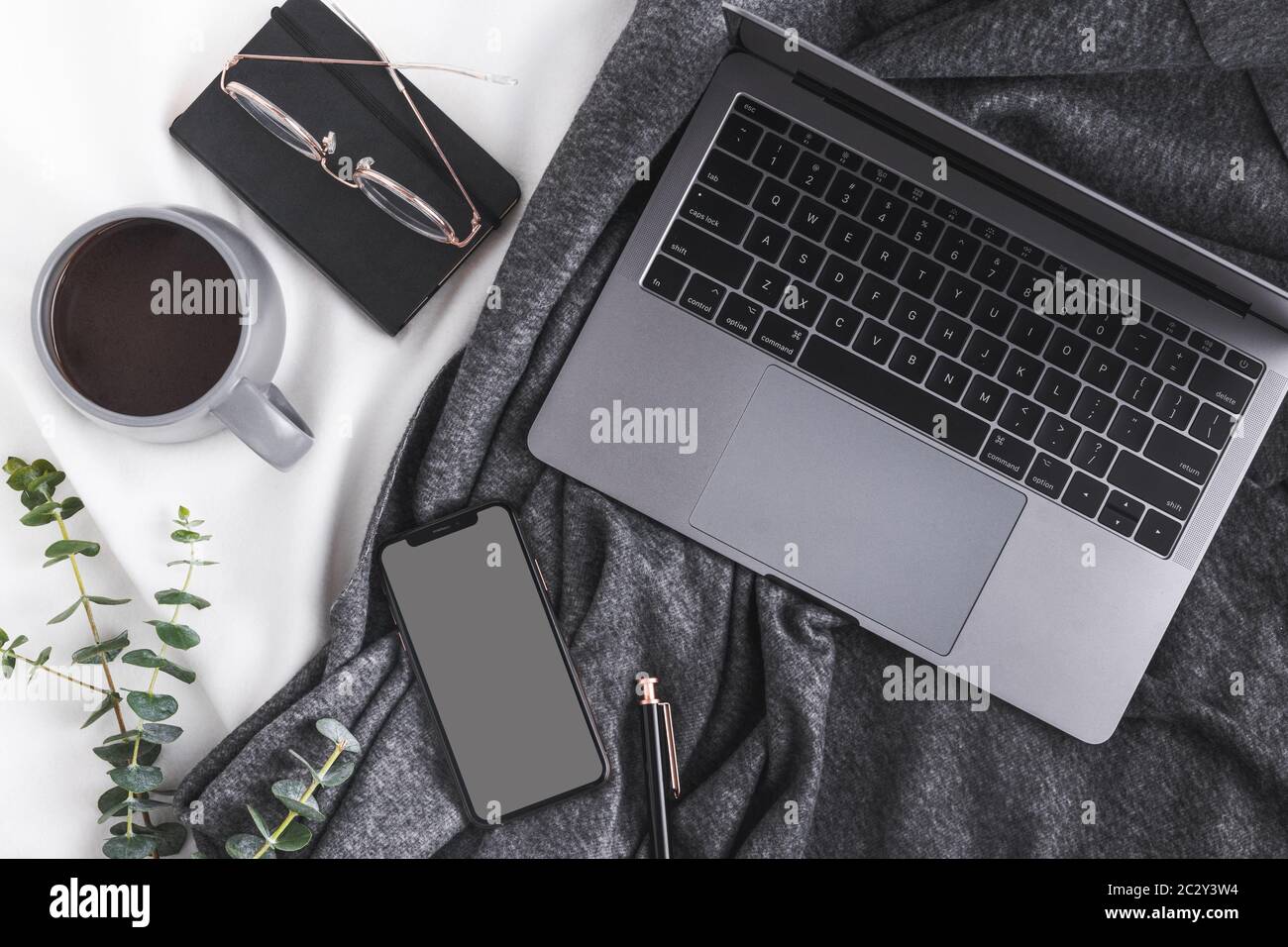 Electronics layout in a white and gray bed flat lay Stock Photo - Alamy
