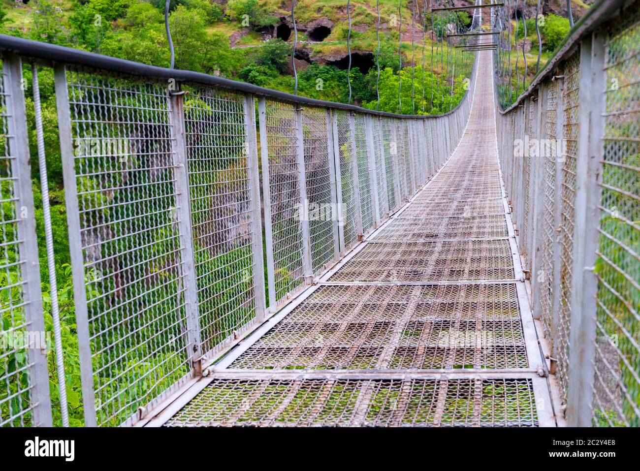Metal mesh suspension bridge over the gorge - a landmark of Armenia in ...