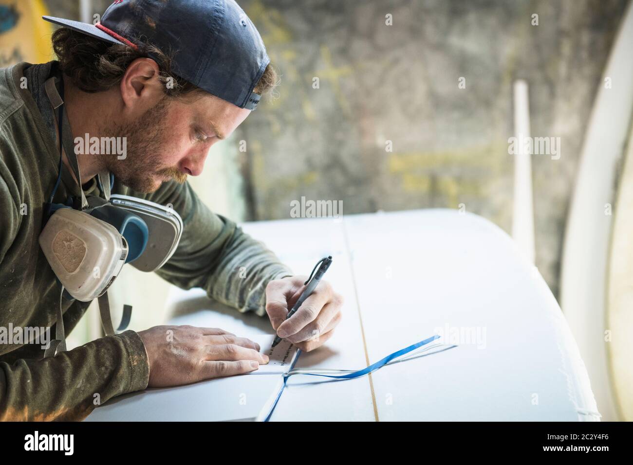 Surfboard Shaper creating a new design Stock Photo - Alamy
