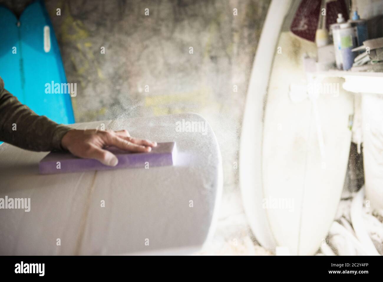 Surfboard Shaper sanding a new design Stock Photo - Alamy