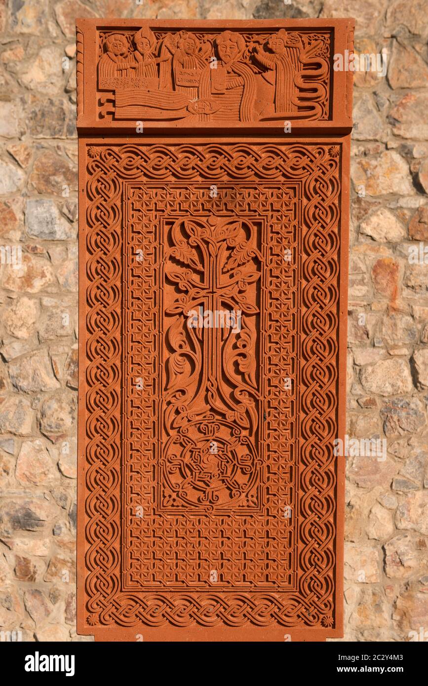 Traditional Armenian khachkar with a carved pattern on a stone close-up ...