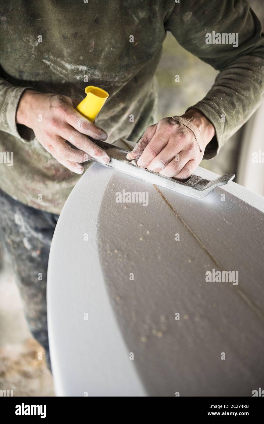 Surfboard Shaper refining a new design Stock Photo - Alamy