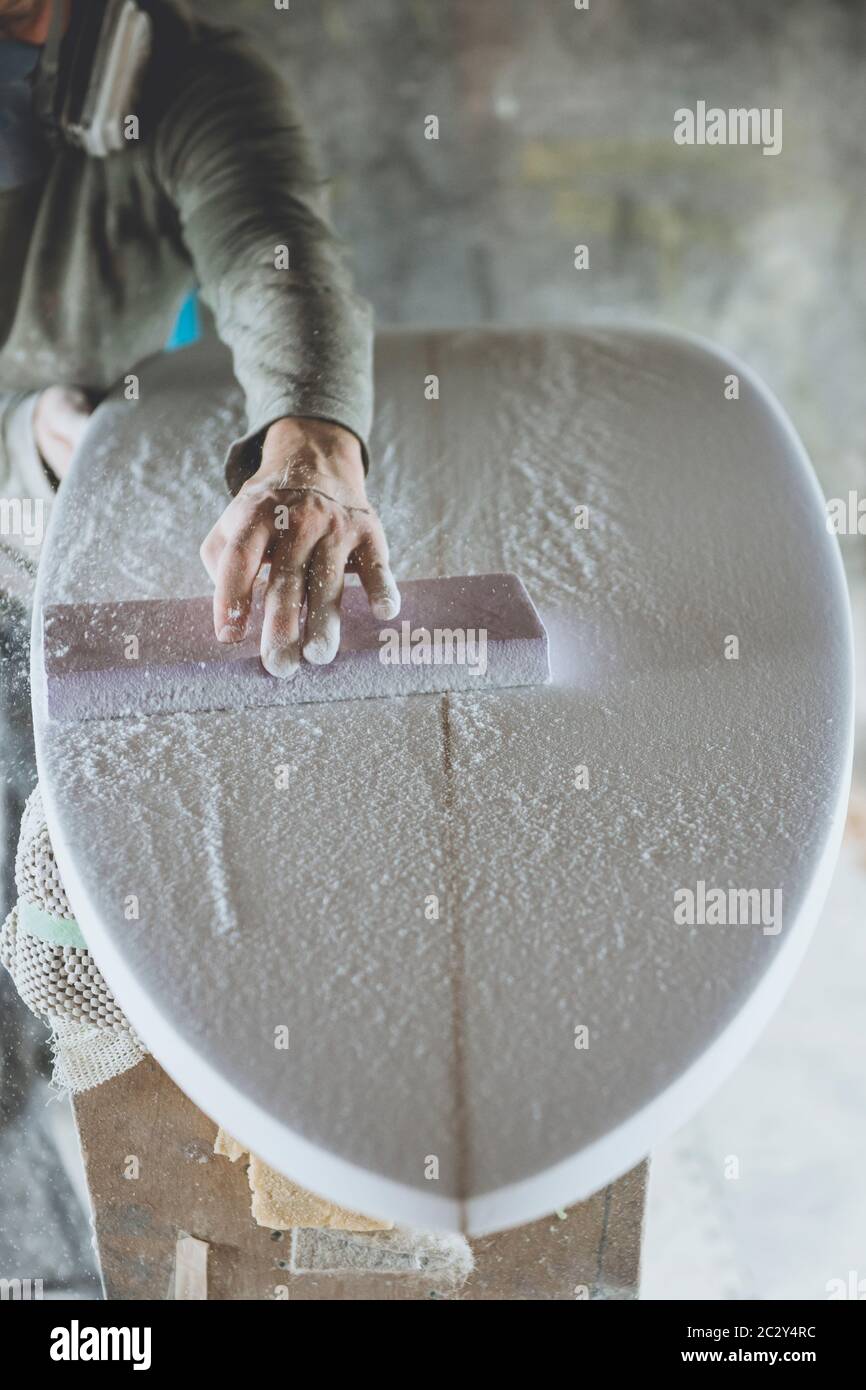 Surfboard Shaper refining a new design Stock Photo - Alamy